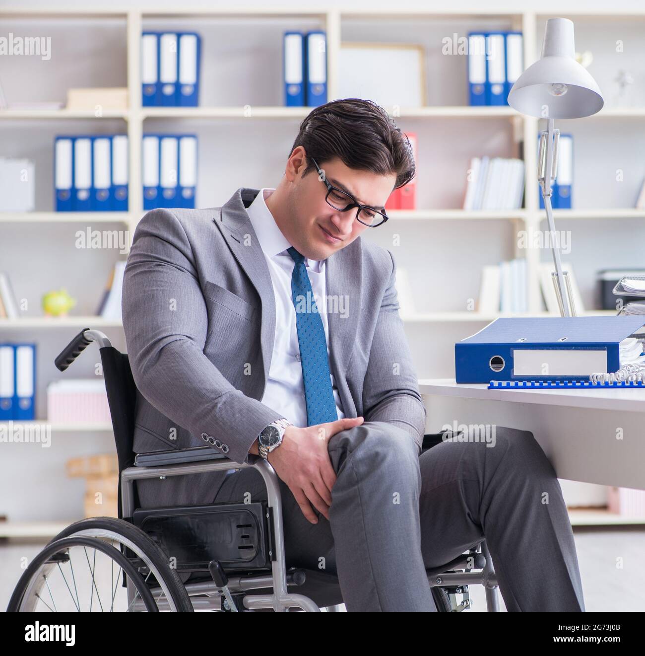 The disabled businessman working in the office Stock Photo - Alamy