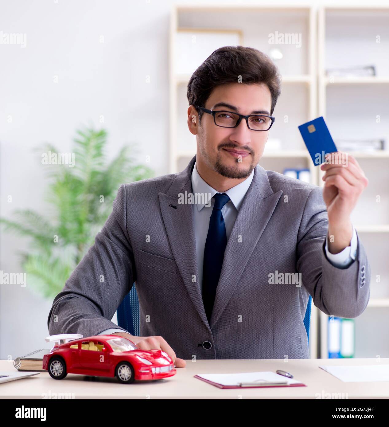 The agent offering car motor insurance Stock Photo - Alamy