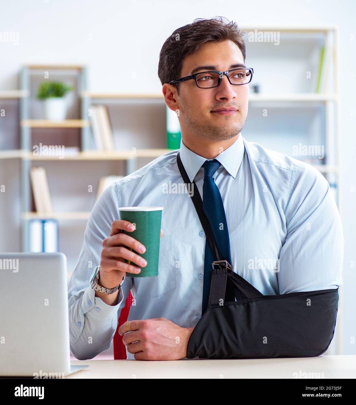 The businessman with broken arm working in office Stock Photo - Alamy
