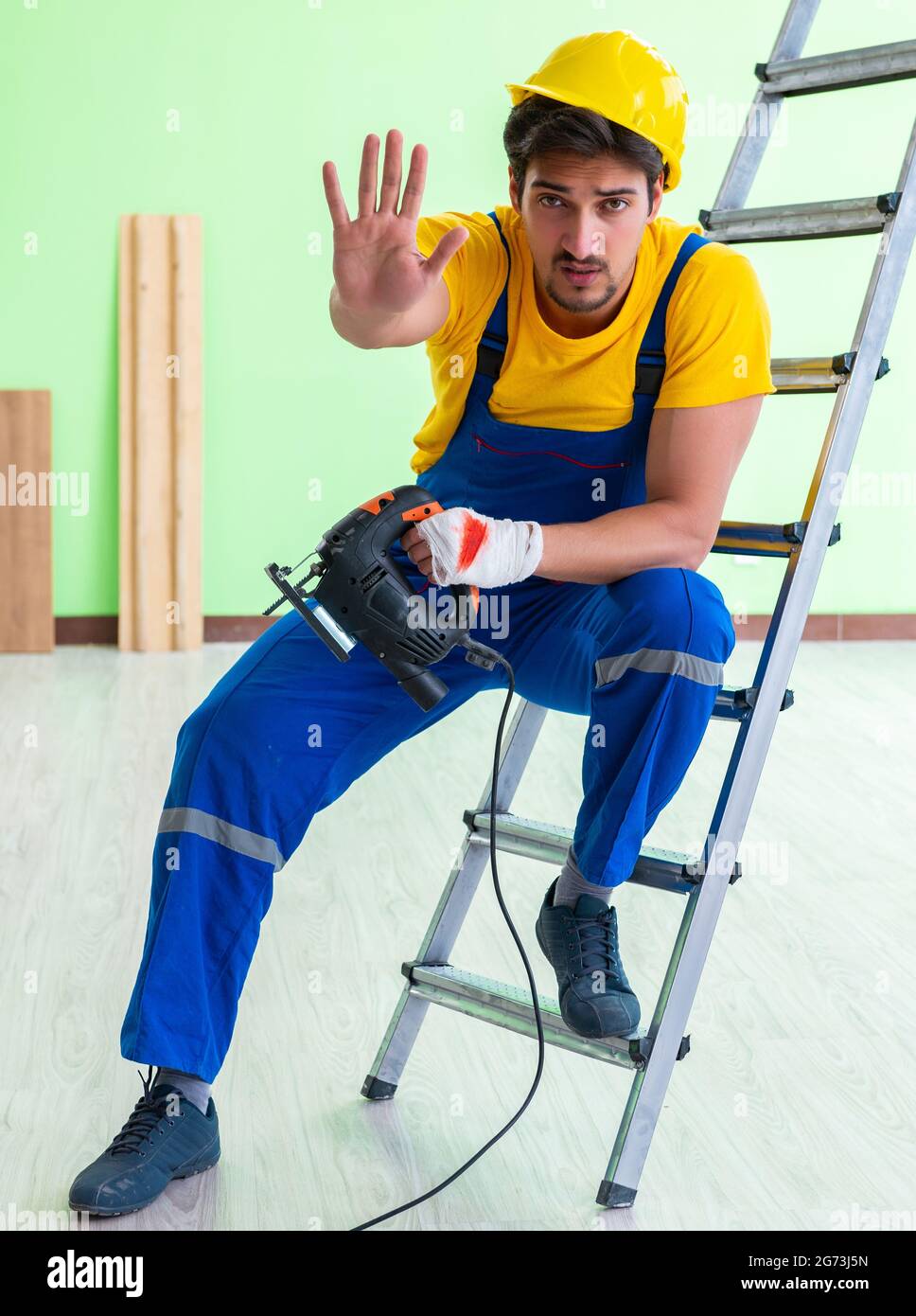 The injured worker at the work site Stock Photo - Alamy
