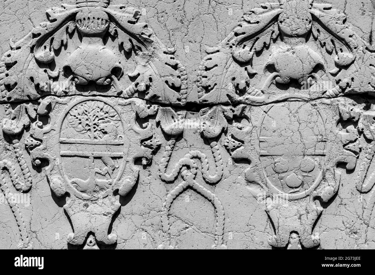 Grayscale of emblems carved on a wall Stock Photo - Alamy