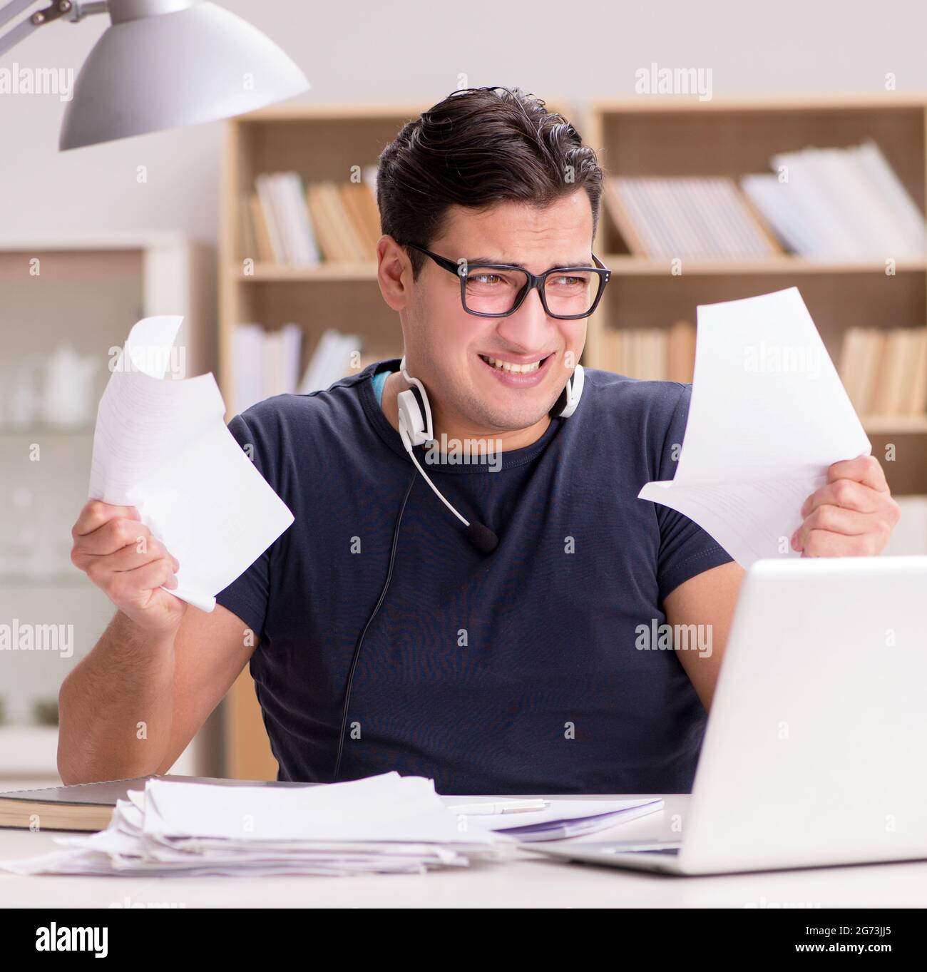 The angry man tearing apart his paperwork due to stress Stock Photo - Alamy