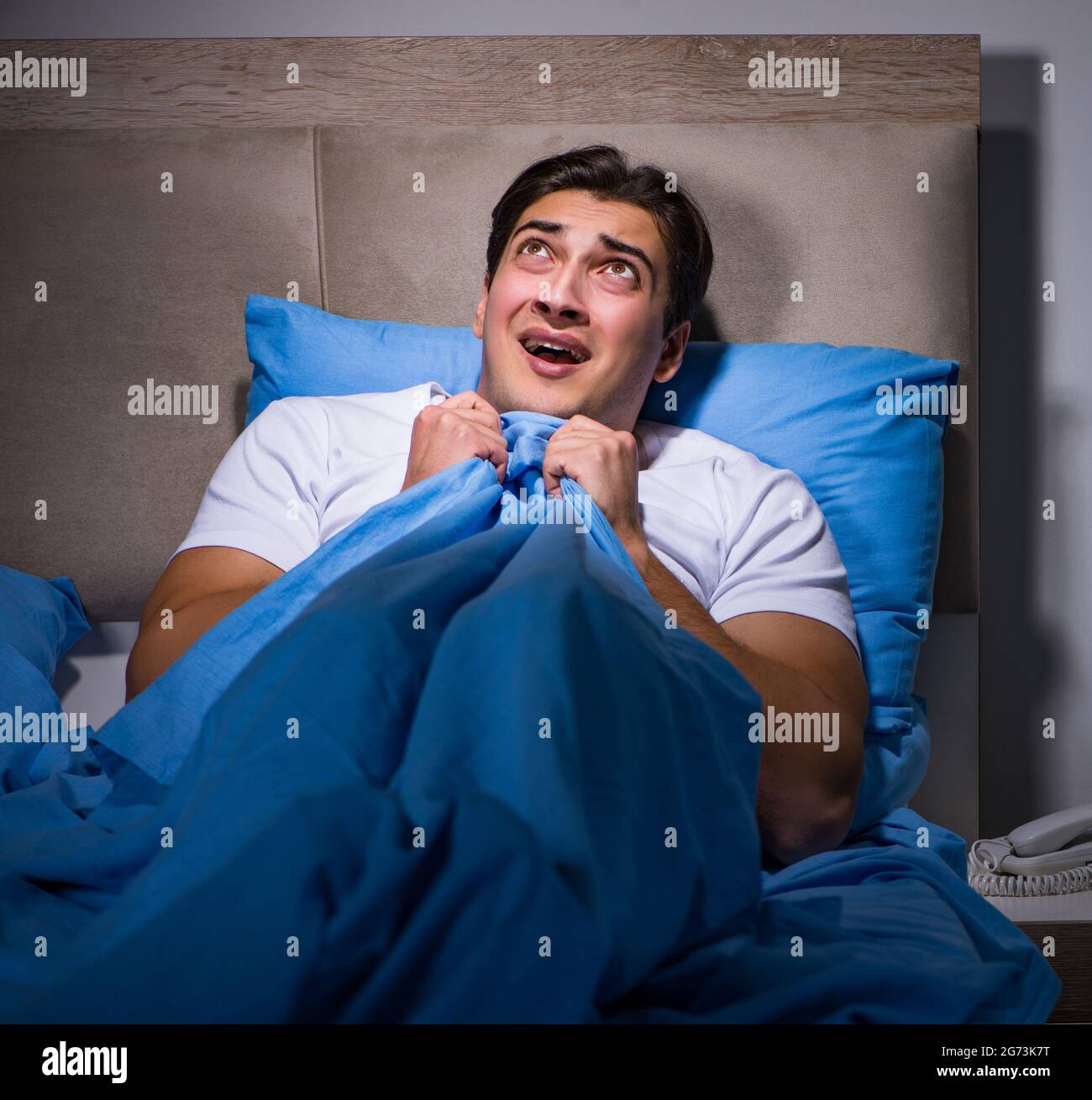 Frightened man lying in bed hi-res stock photography and images - Alamy