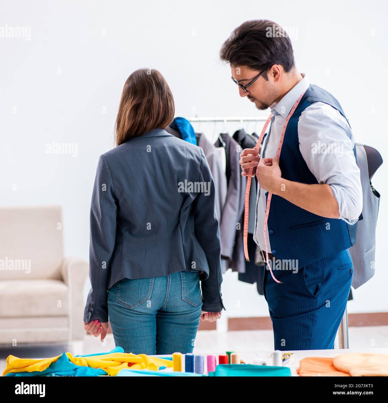 The professional tailor taking measurements for formal suit Stock Photo - Alamy