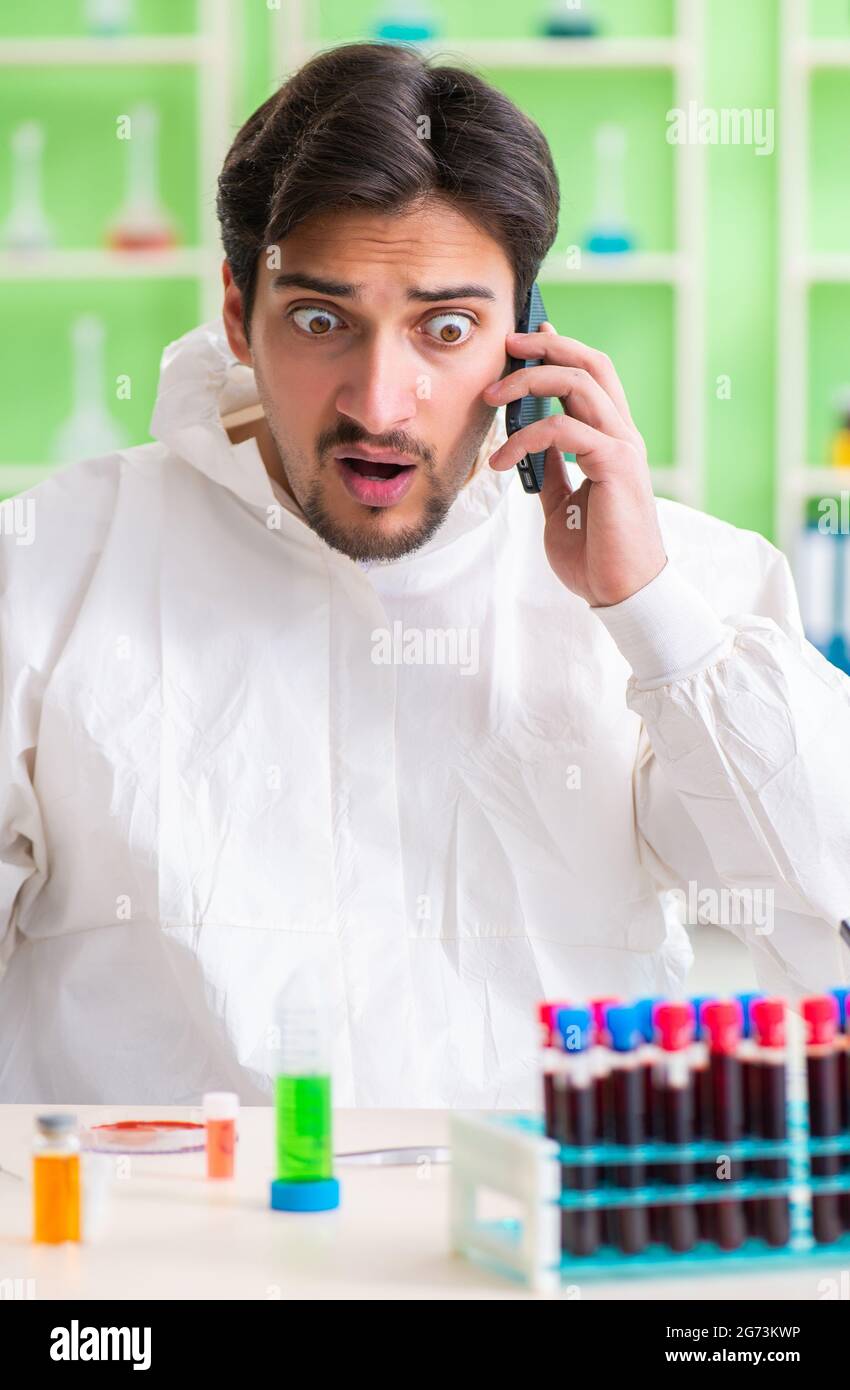 Chemist examining liquid solution speaking hi-res stock photography and ...