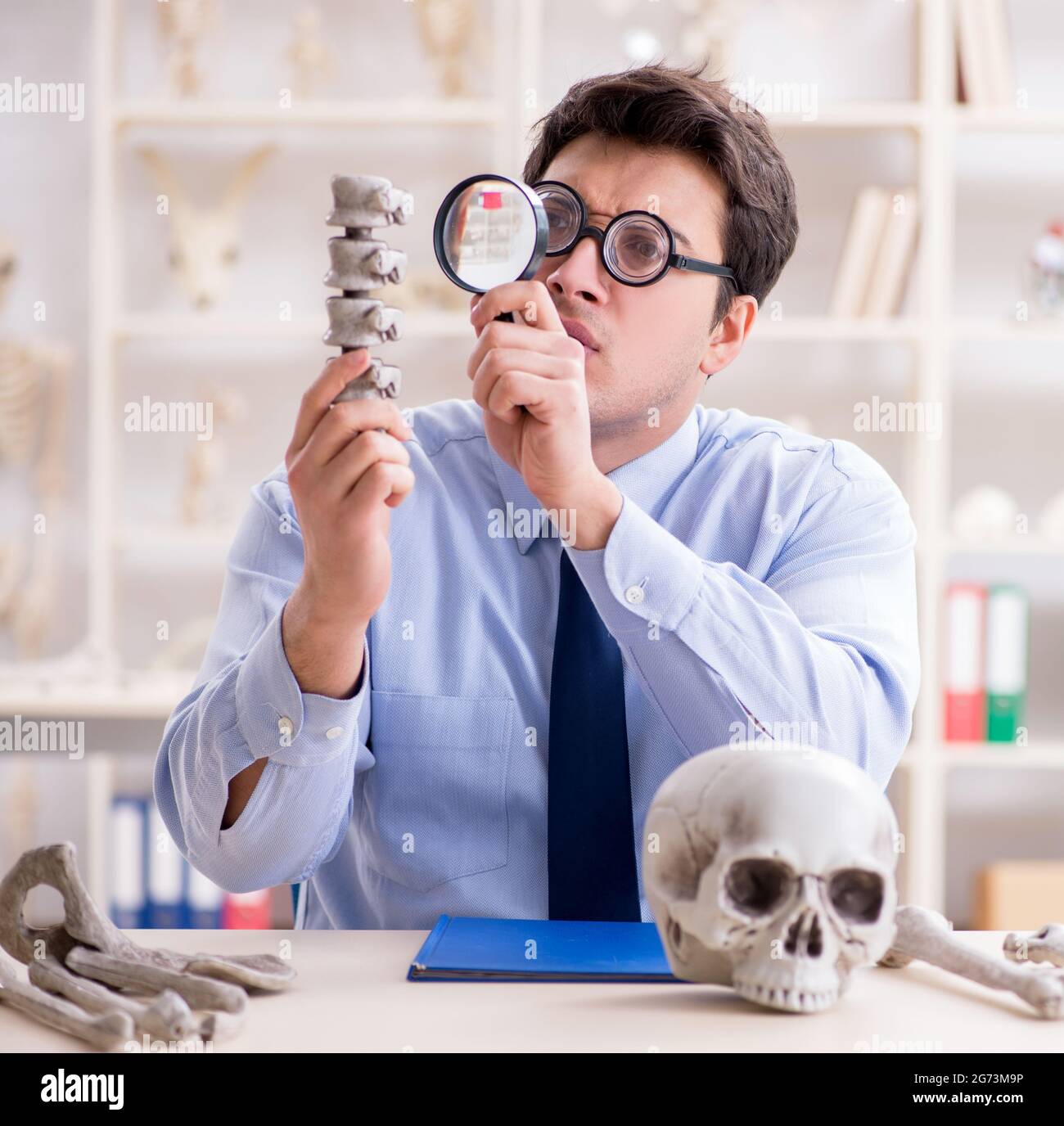 The funny crazy professor studying human skeleton Stock Photo - Alamy