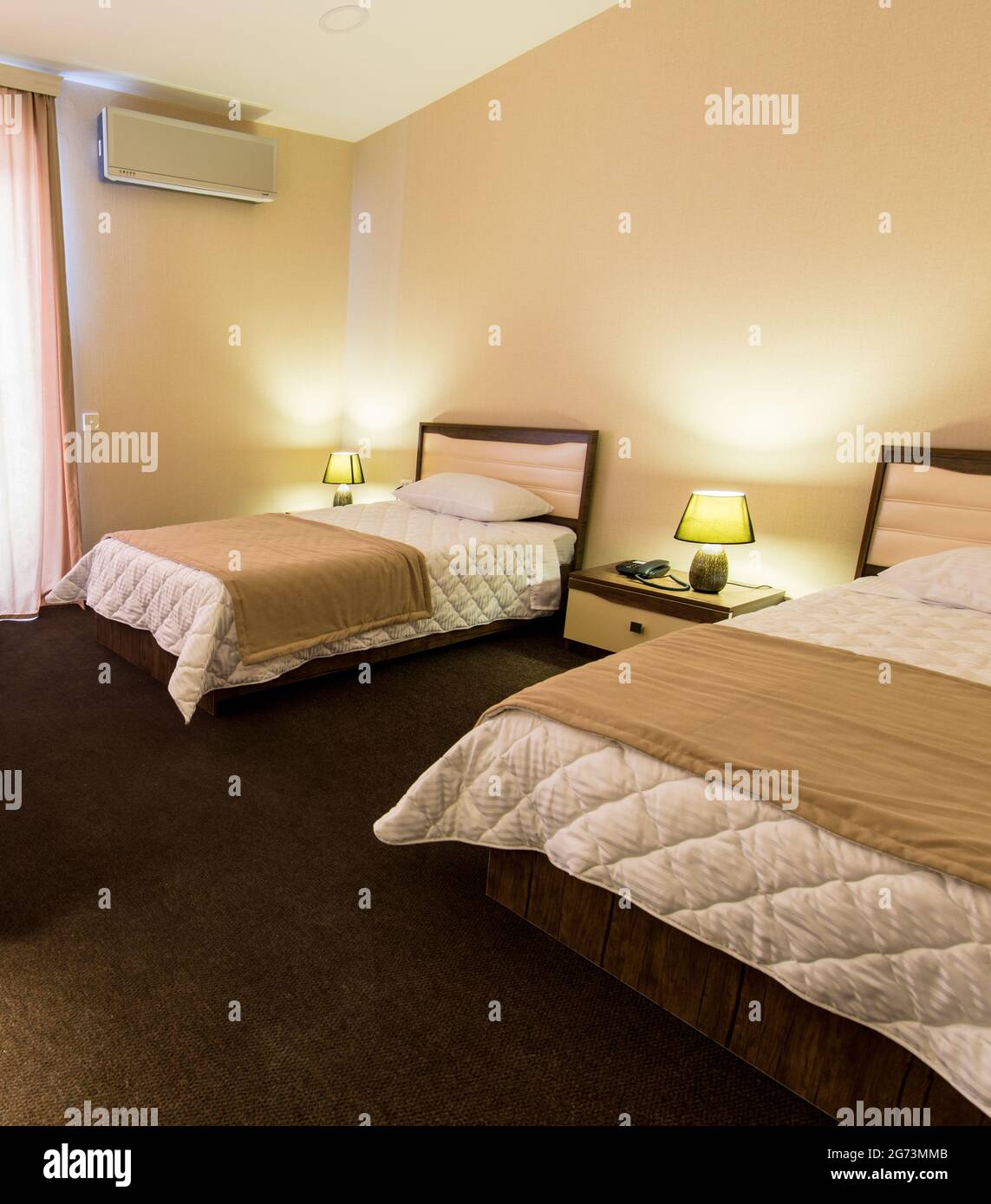 The triple room in modern hotel Stock Photo - Alamy