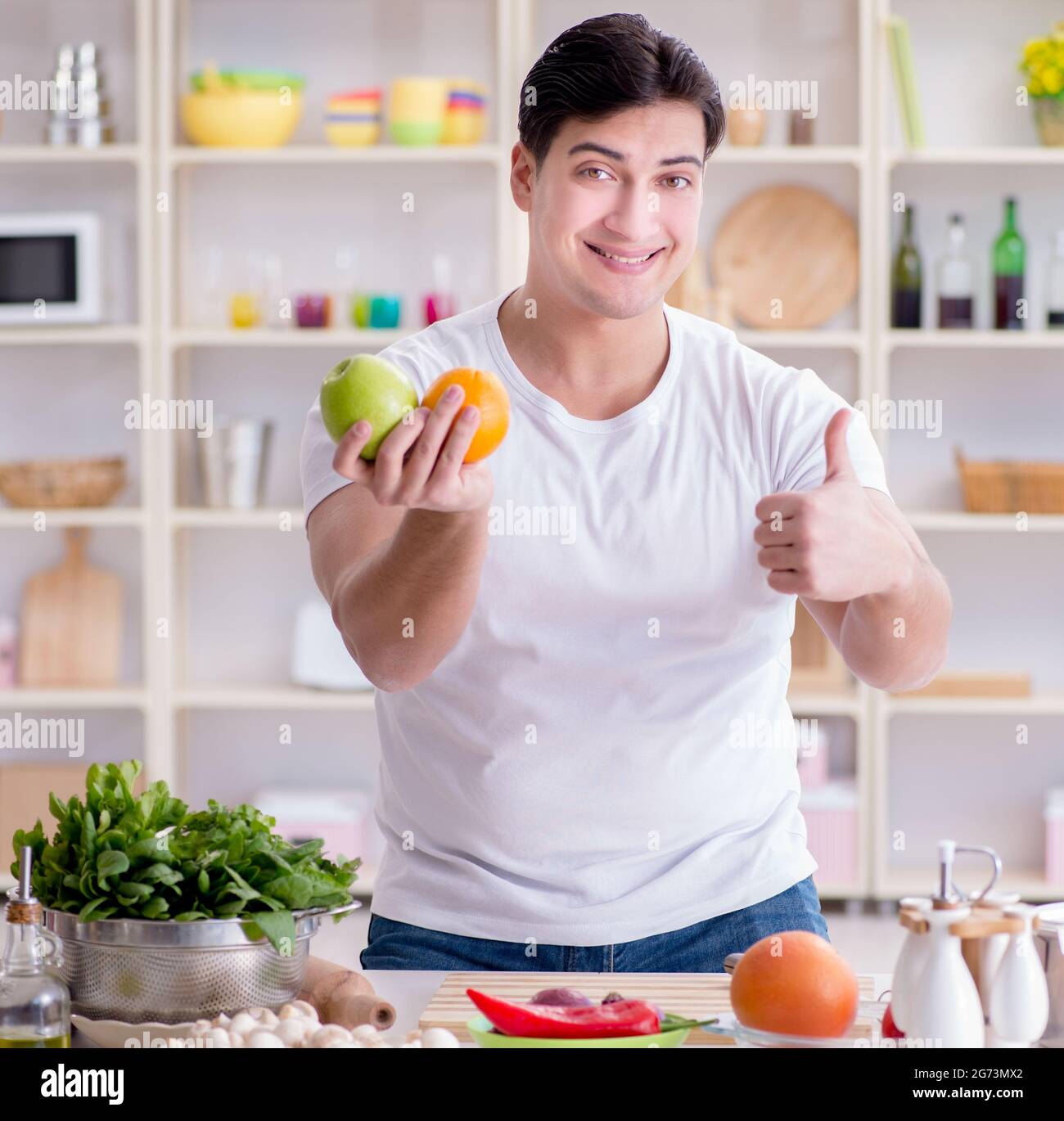 The young male cook working in the kitchen Stock Photo - Alamy