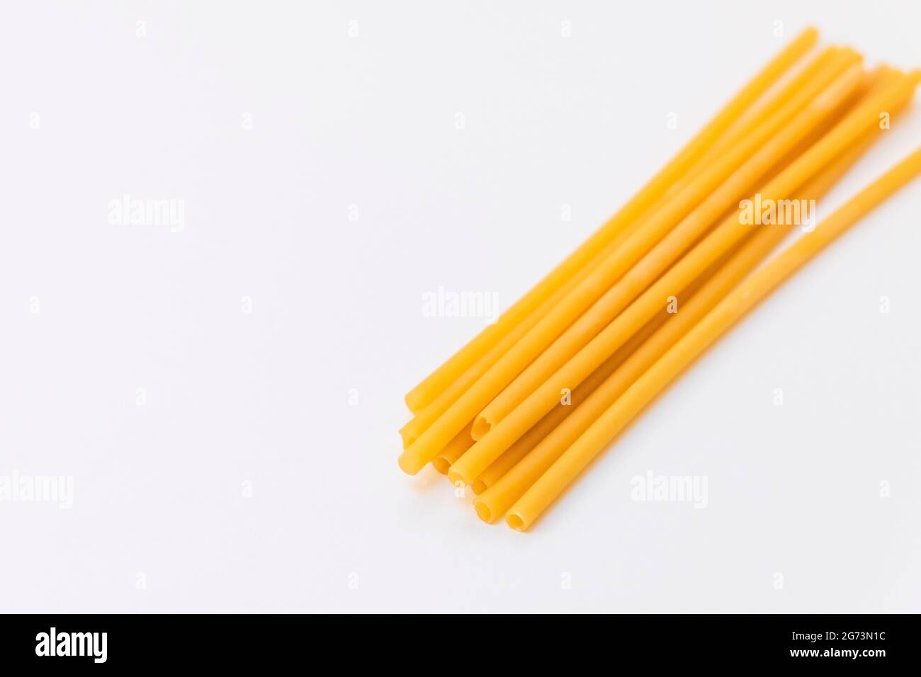 Top view of eco-friendly pasta straws on light background with copy ...