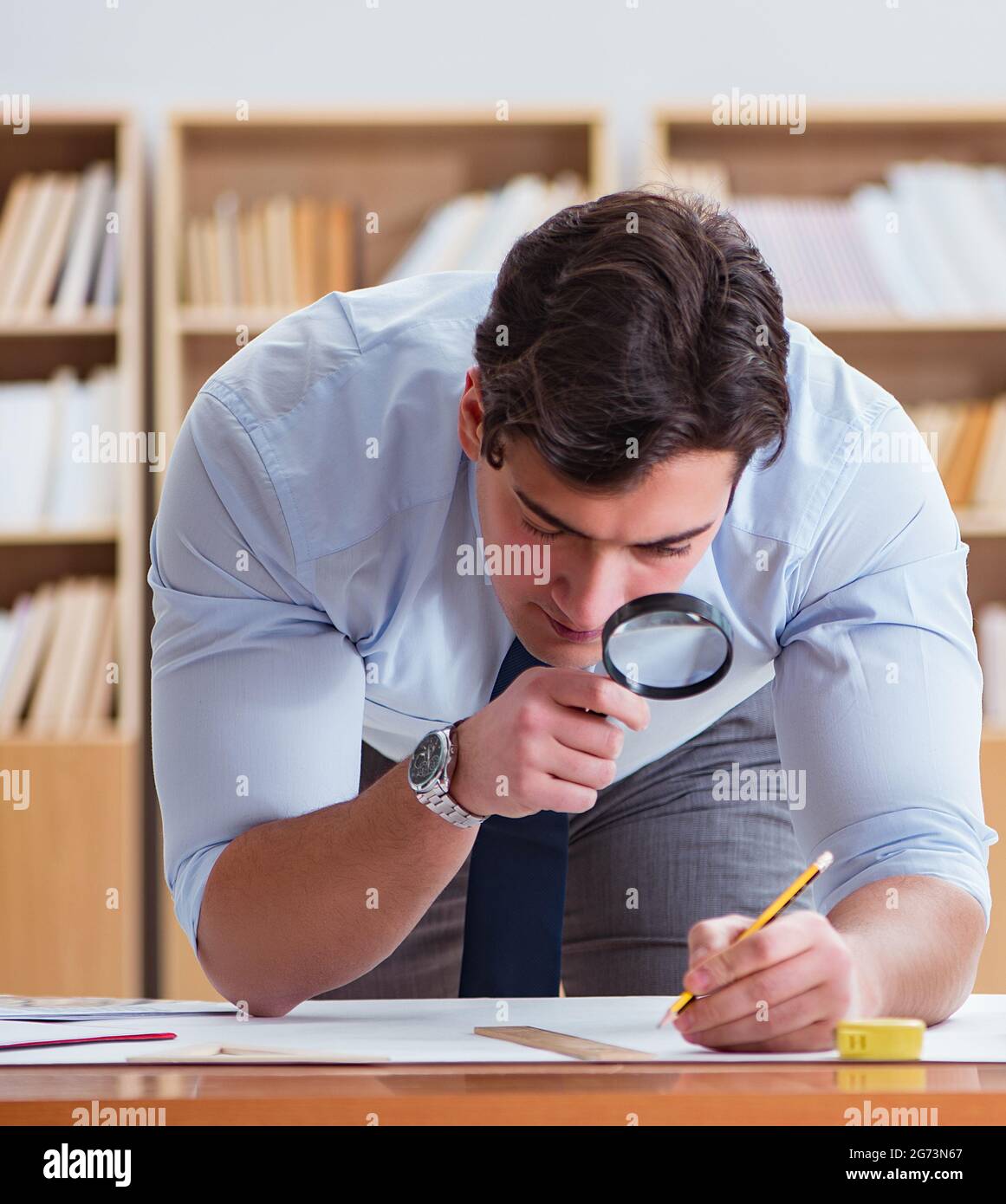 The engineer supervisor working on drawings in the office Stock Photo ...