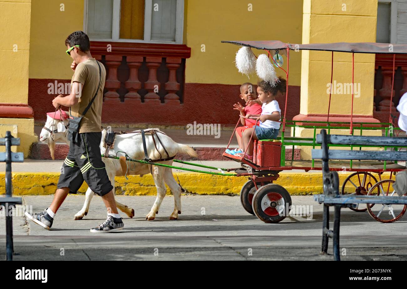 Cuban dad takes two children riding cart towed by goat hi-res stock ...