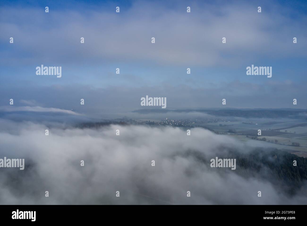 Aerial view of dense white mist covering green trees Stock Photo - Alamy