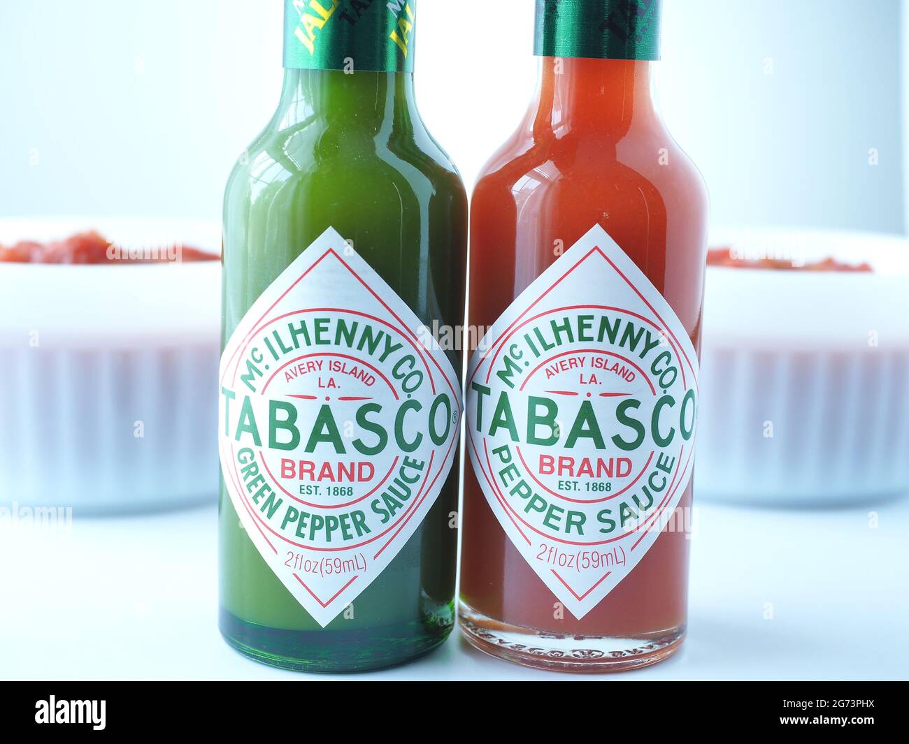 Red and Green Tabasco sauce with two bowls of salsa Stock Photo - Alamy
