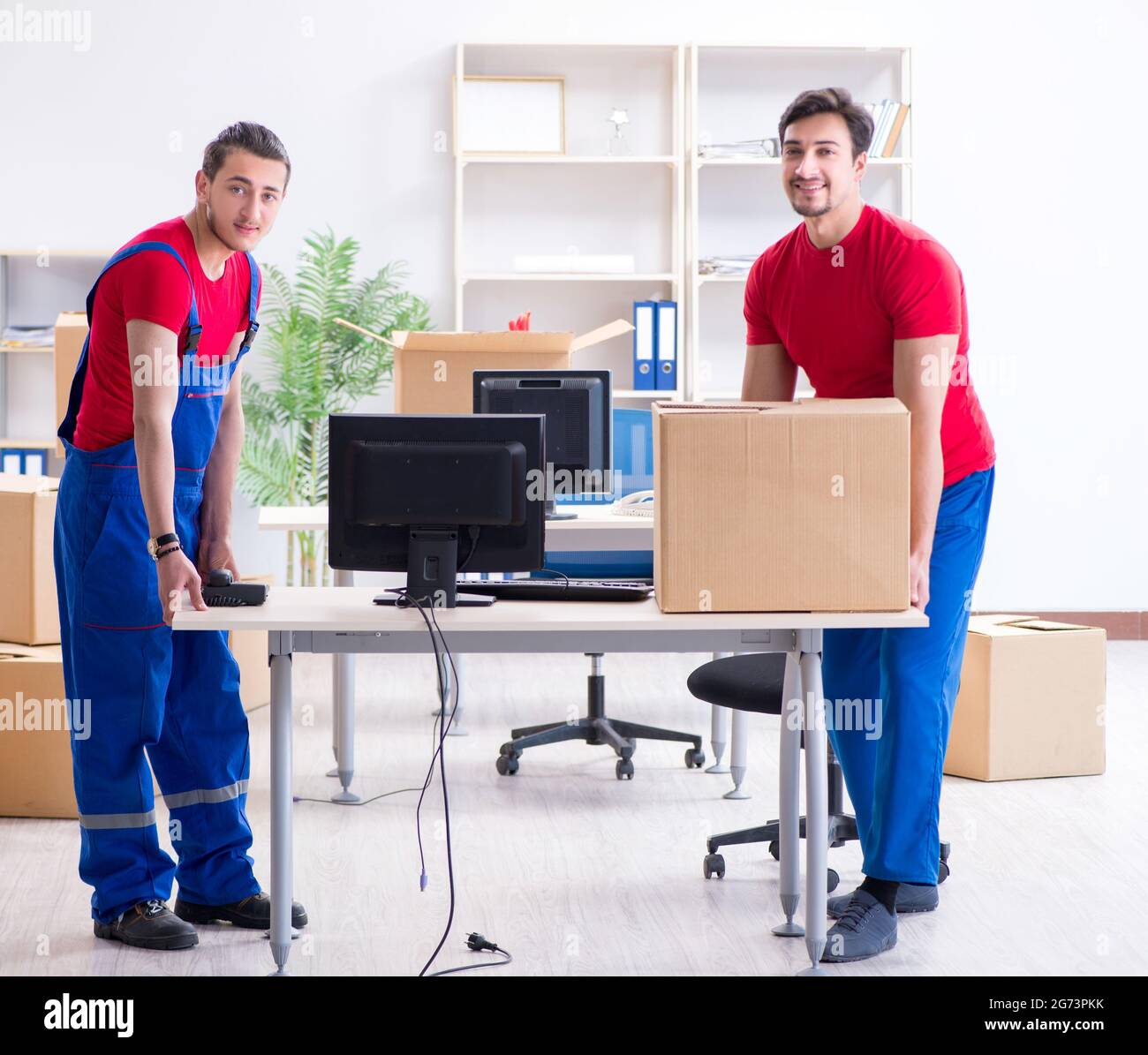 The two contractor employees moving personal belongings Stock Photo - Alamy