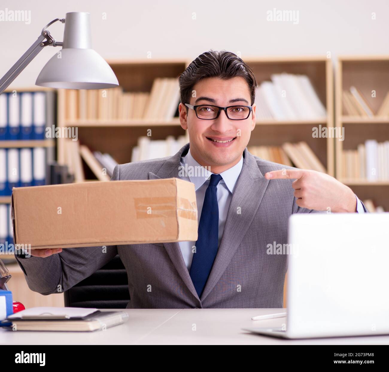 The businessman receiving parcel in the office Stock Photo - Alamy