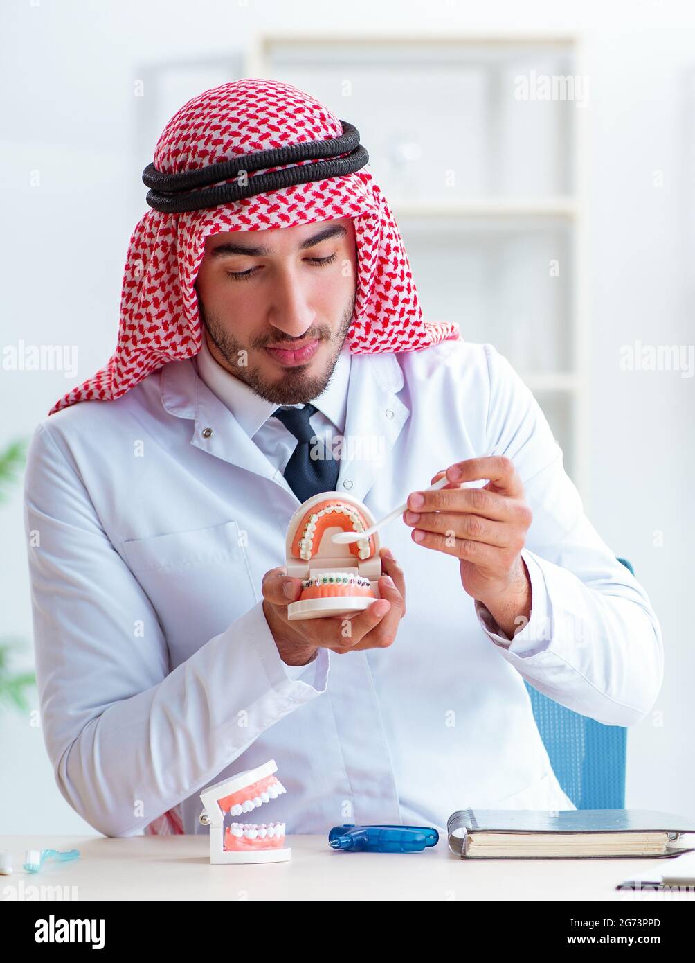 The arab dentist working on new teeth implant Stock Photo - Alamy