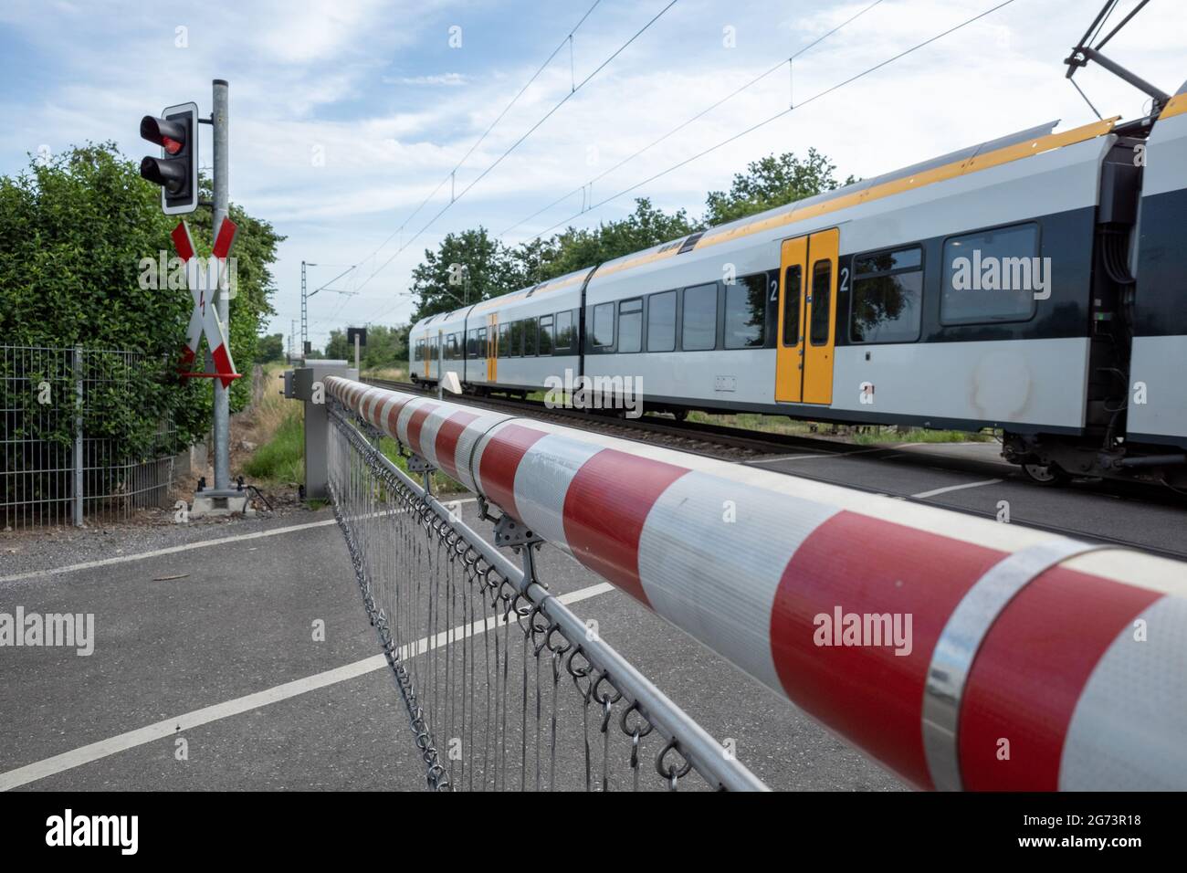 Selective focus view at red and white level crossing railway barrier ...