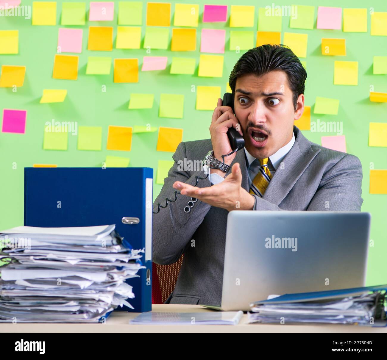 The businessman having trouble with his priorities Stock Photo - Alamy