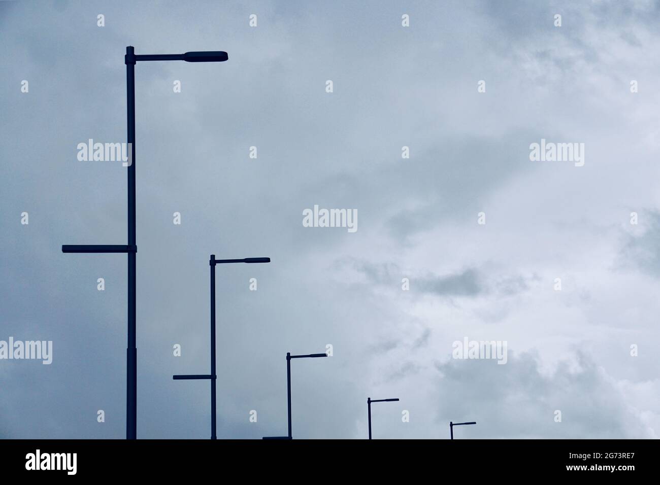 Low angle shot of lamp posts with gloomy sky in a background Stock ...
