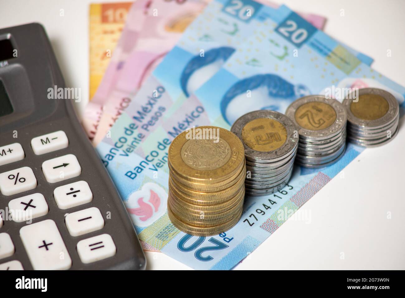 A closeup of coins stacked in columns on a white background Stock Photo ...