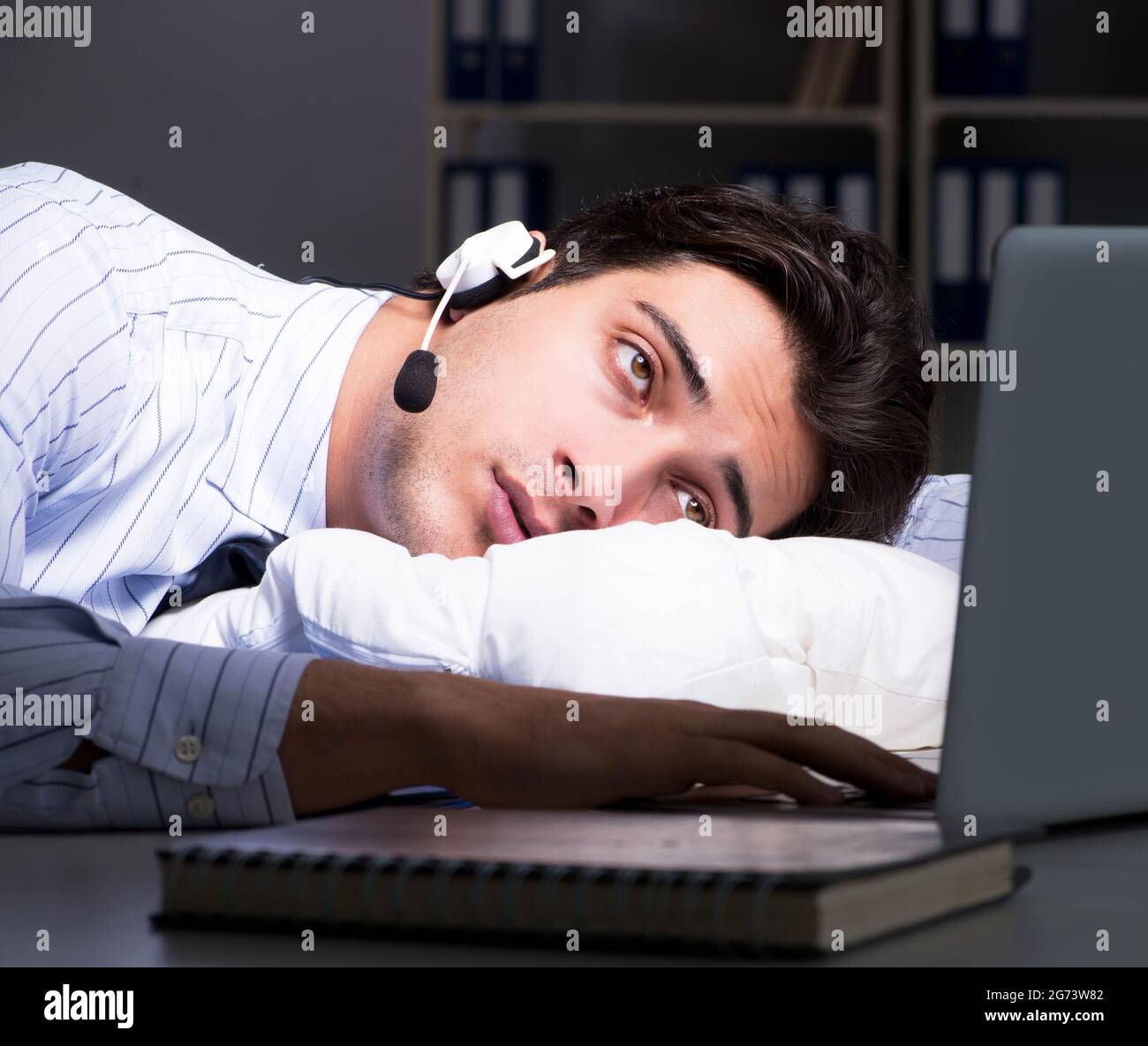 The tired and exhausted helpdesk operator during night shift Stock ...