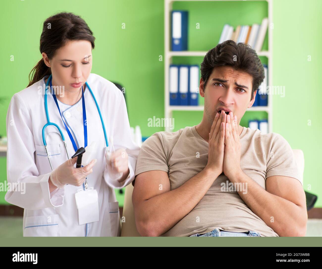 The female doctor checking patient's ear during medical examination ...