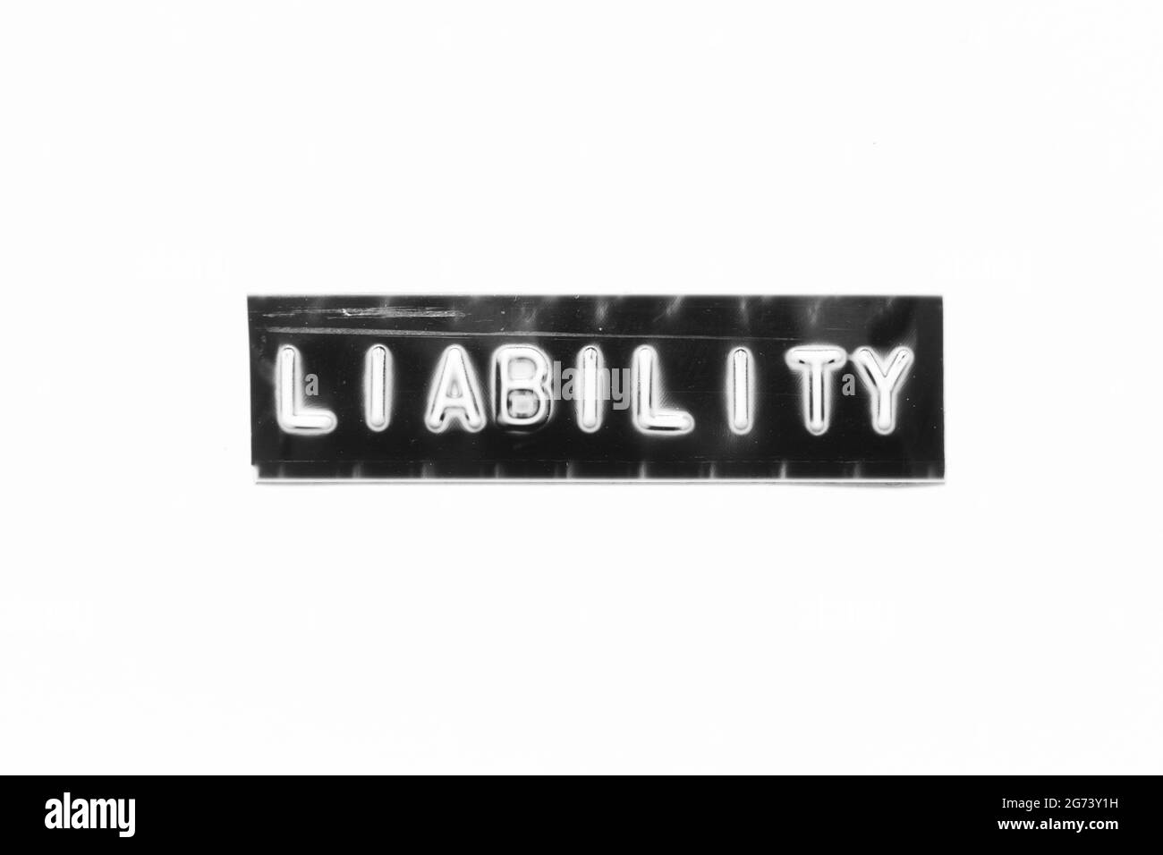 Embossed letter with word liability in black banner on white paper ...