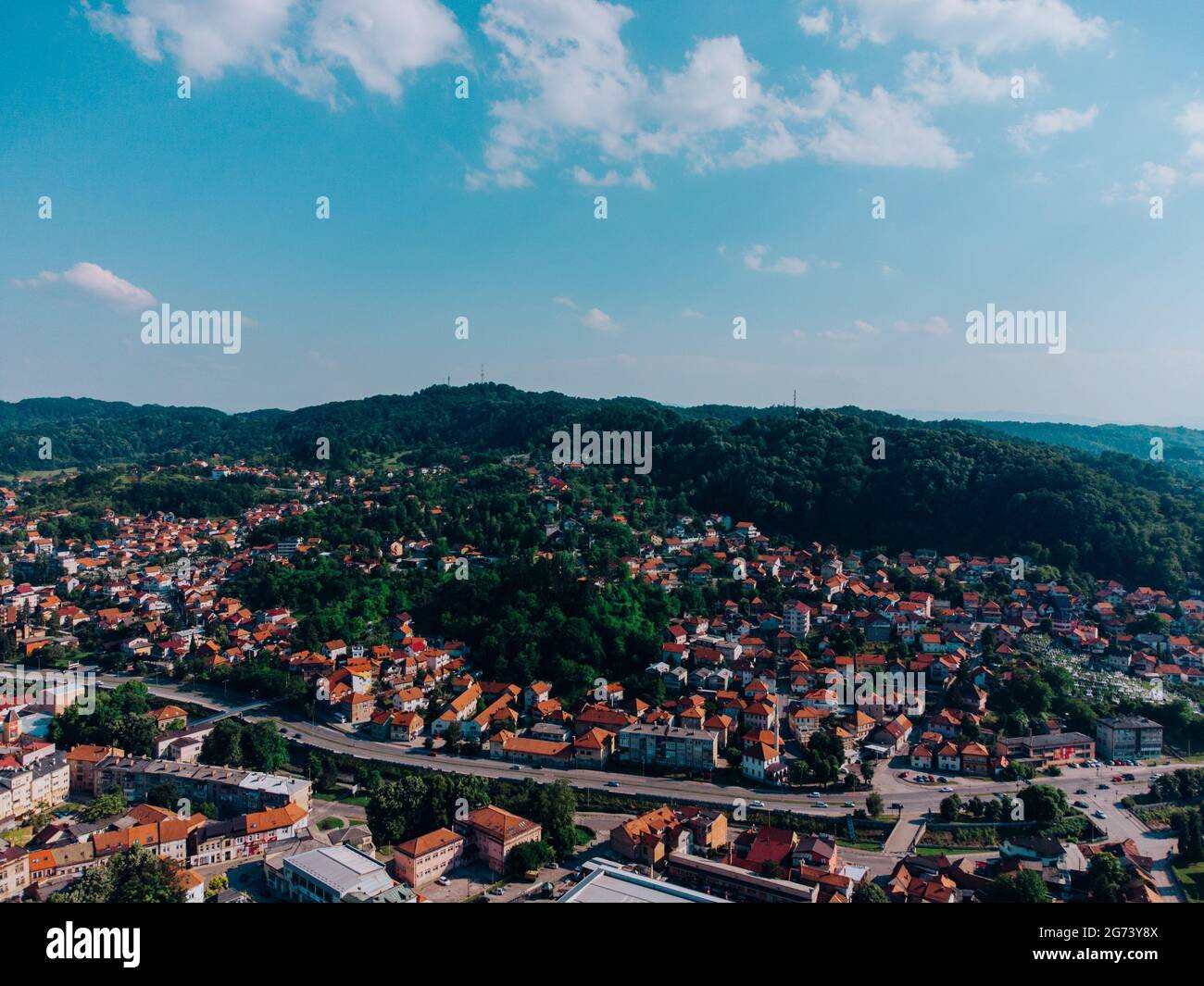 An aerial shot of the cityscape of Tuzla, Bosnia, under the blue sky ...