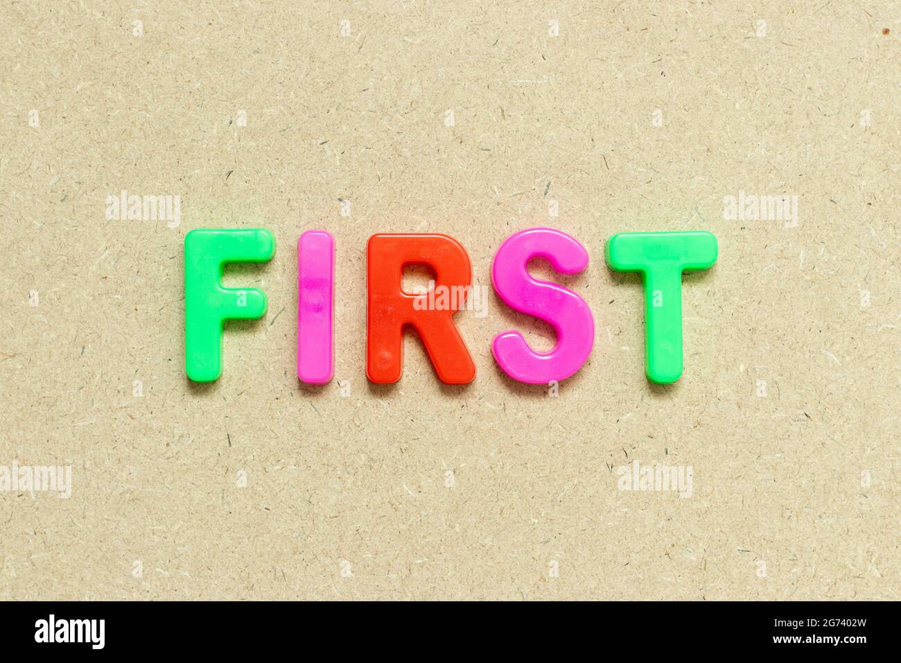 Color alphabet letter with word first on wood background Stock Photo ...