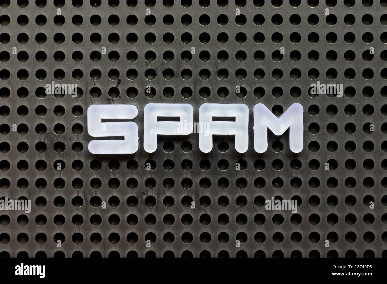 White color letter in word spam on black pegboard background Stock ...