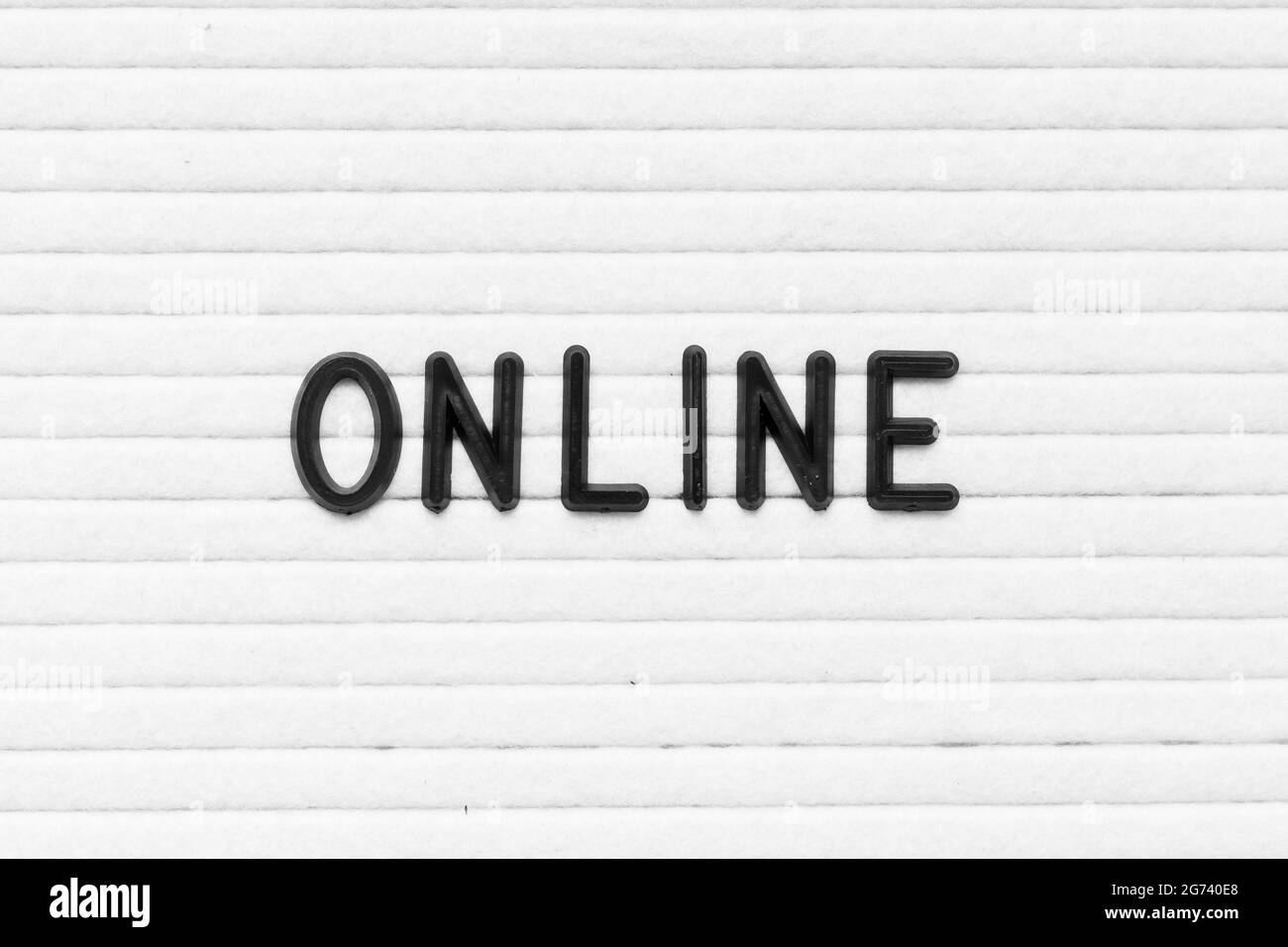 Black color letter in word online on white felt board background Stock ...