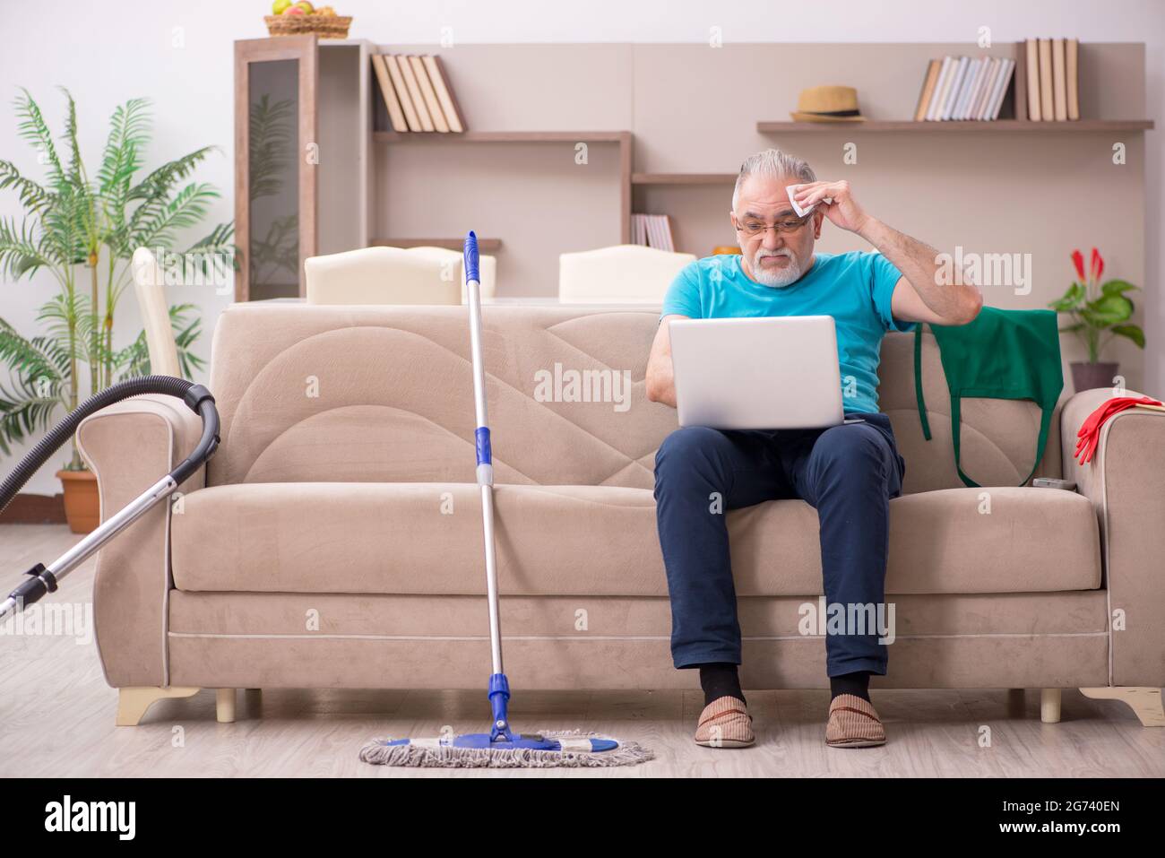 Aged man cleaning the house Stock Photo - Alamy