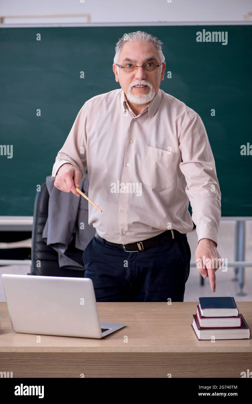 Old teacher in front of blackboard Stock Photo - Alamy