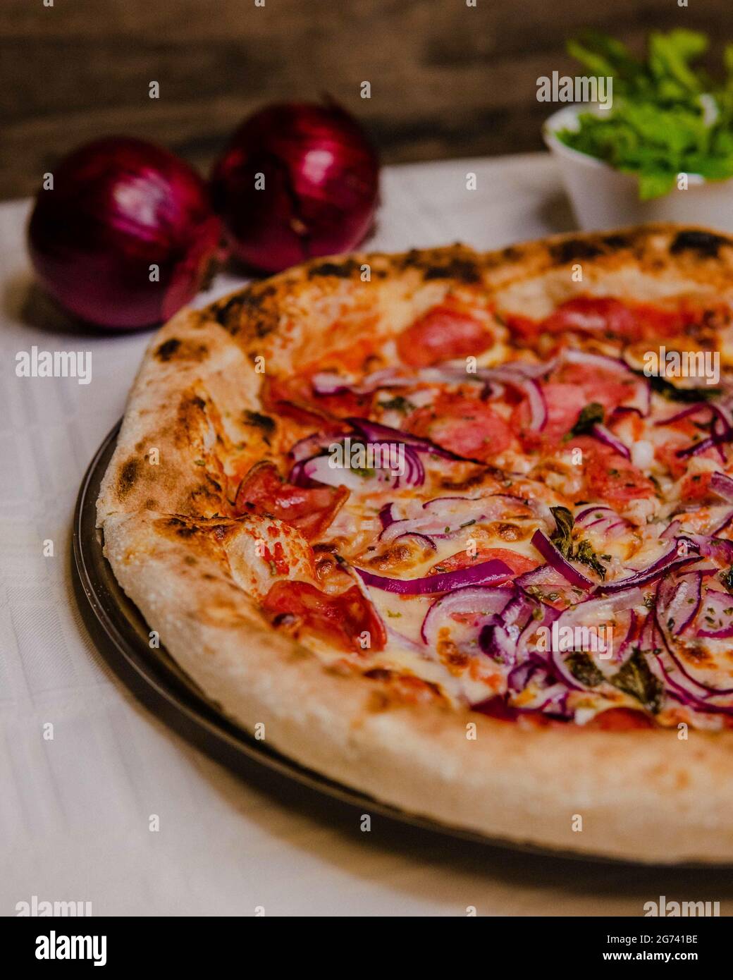 A delicious crispy pizza with onions Stock Photo - Alamy