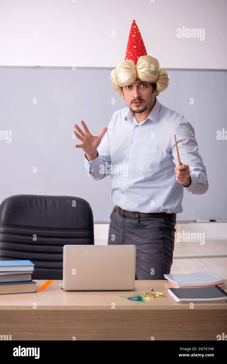 Funny young teacher magician in the classroom Stock Photo - Alamy