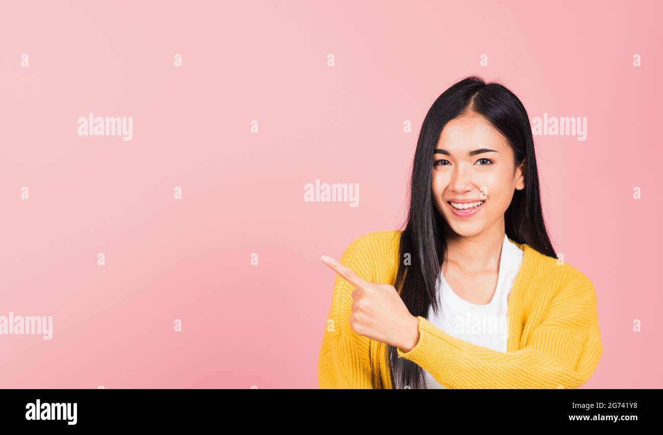 Asian happy portrait beautiful cute young woman standing makes gesture ...