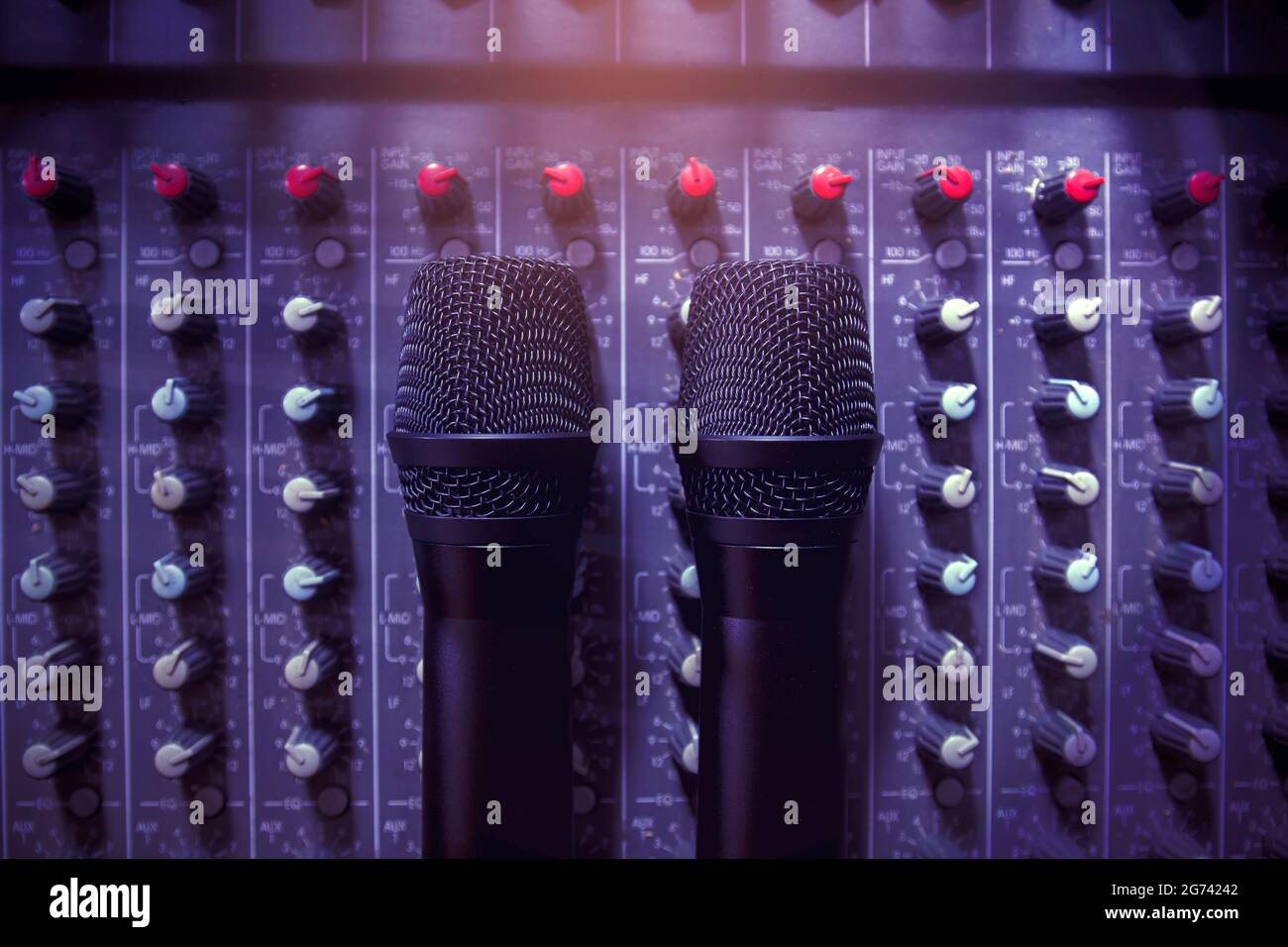 Black two wireless microphone top view on a professional audio mixer in ...
