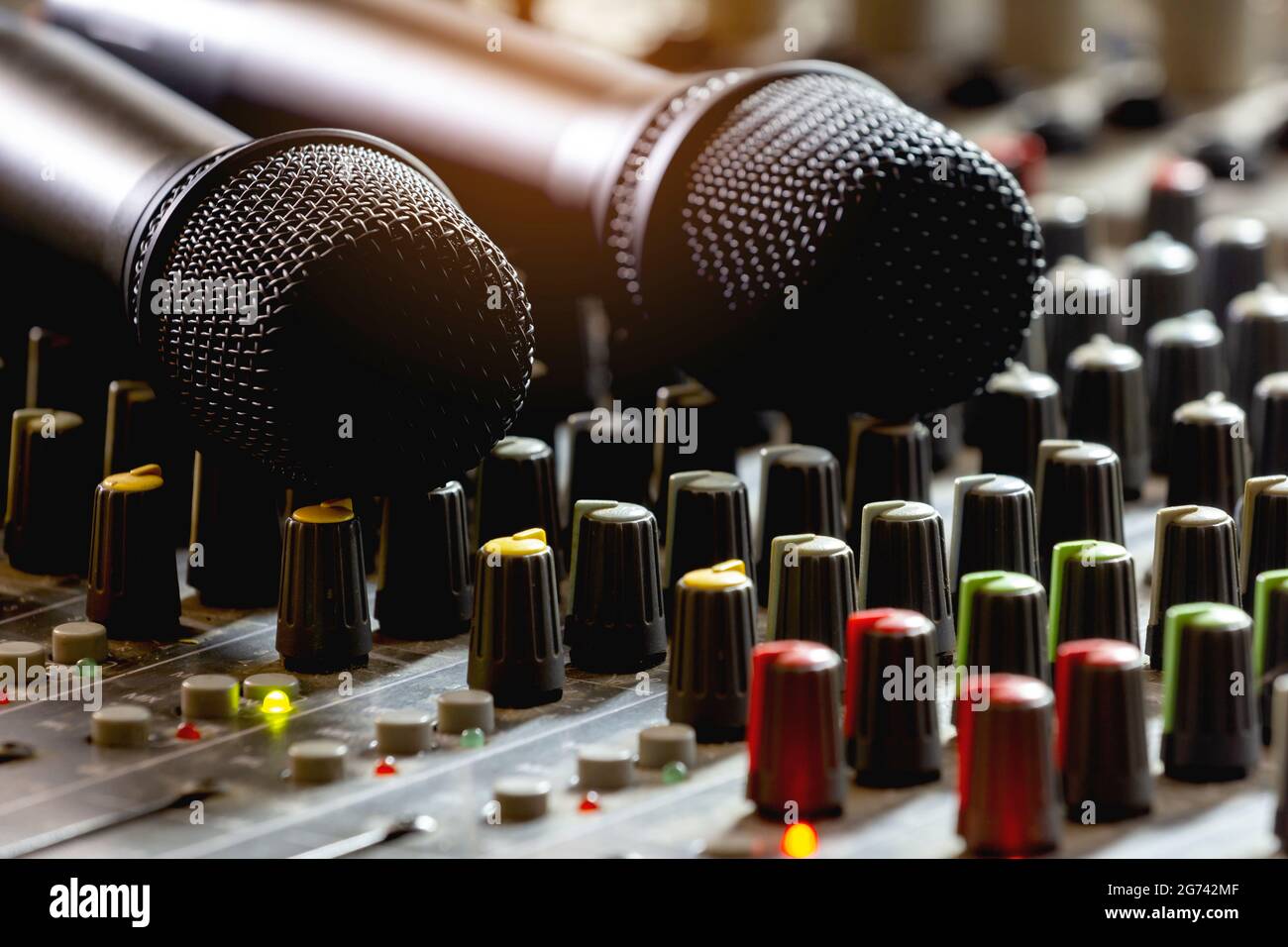 Wireless microphones transmit radio waves on a professional audio mixer ...