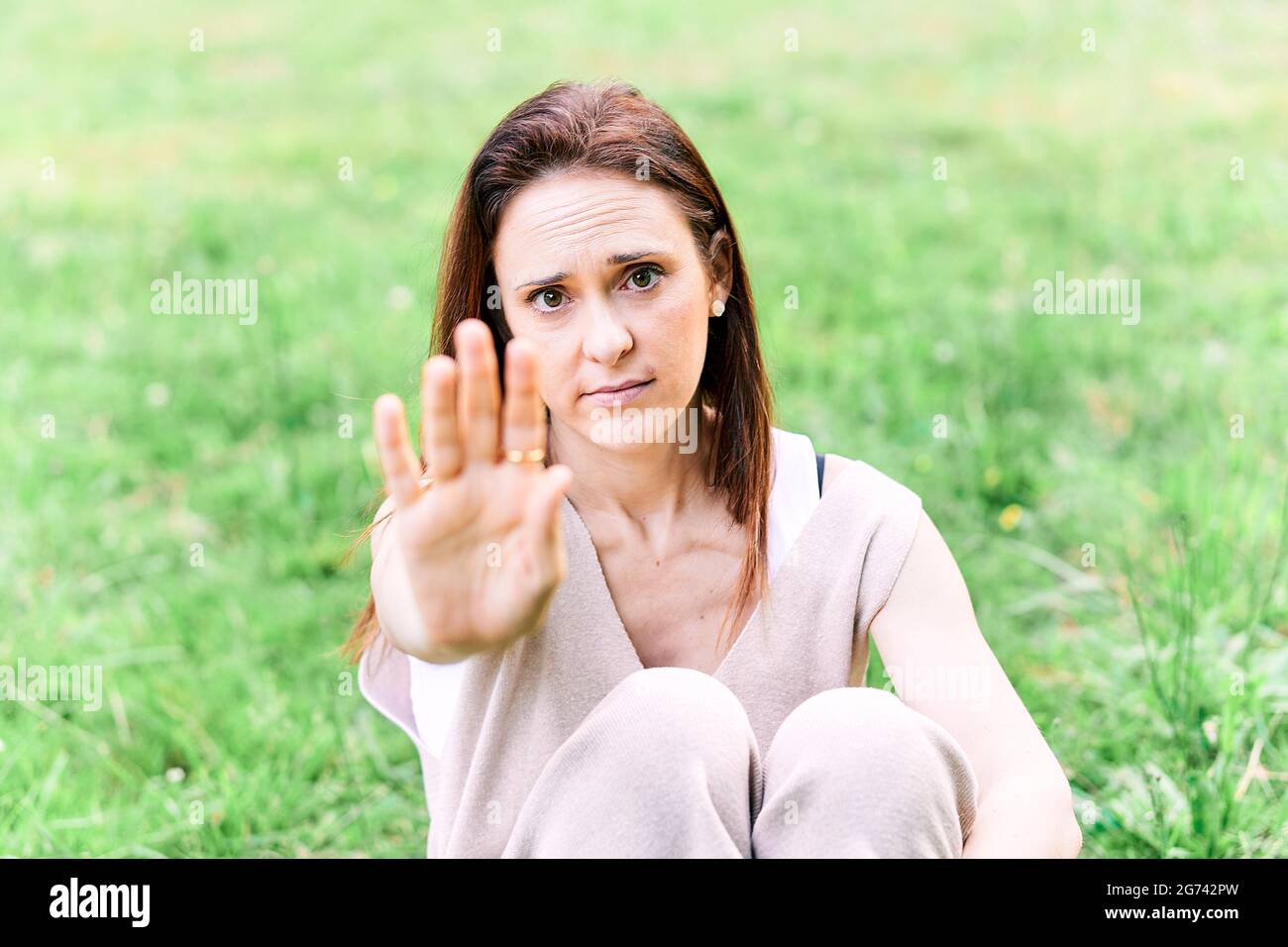 Angry young woman raising hand hi-res stock photography and images - Alamy