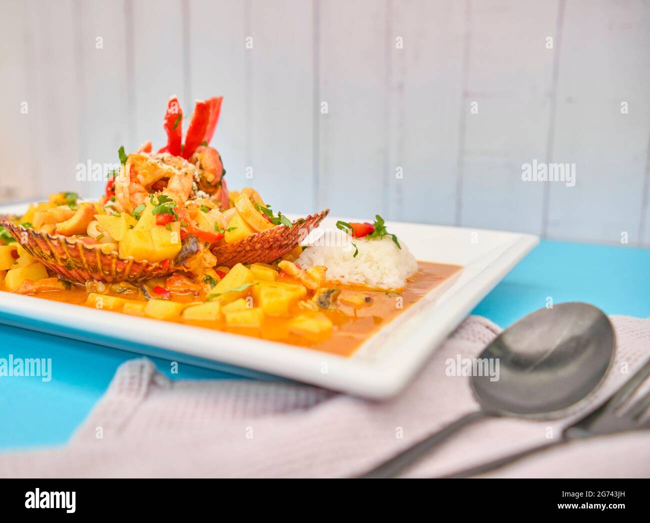PERUVIAN FOOD: Picante de Mariscos with rice, sea food Stock Photo - Alamy