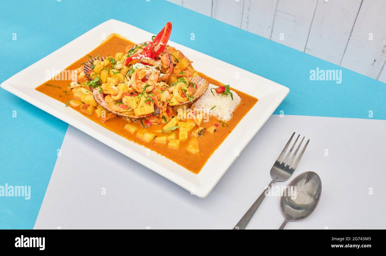 PERUVIAN FOOD: Picante de Mariscos with rice, sea food Stock Photo - Alamy