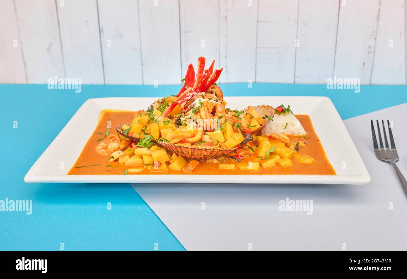 PERUVIAN FOOD: Picante de Mariscos with rice, sea food Stock Photo - Alamy