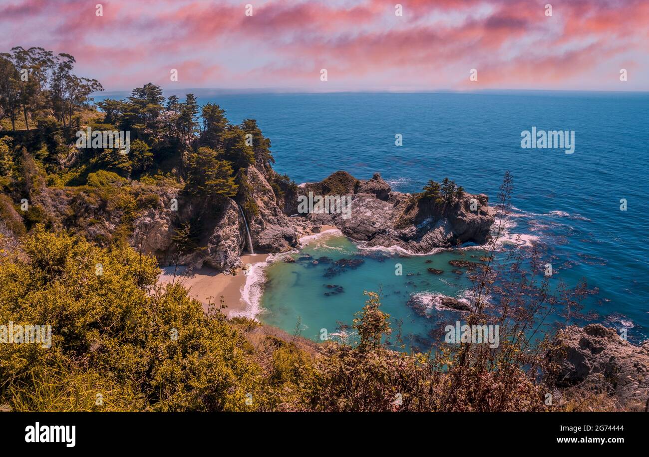 the Mcway Waterfall and its beautiful beach in sunset California United ...