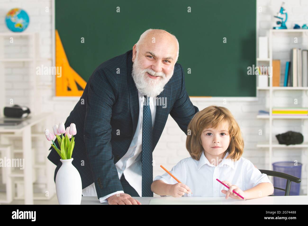 Professor or teacher teaching little student boy. Teacher is skilled ...