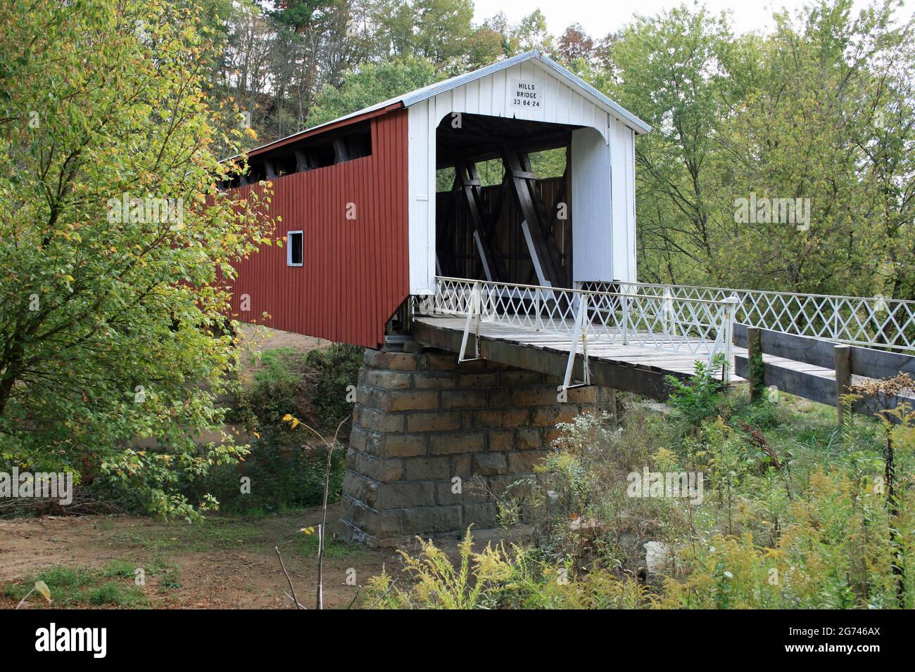 The hills bridge with roof with red walls and trees on the background ...