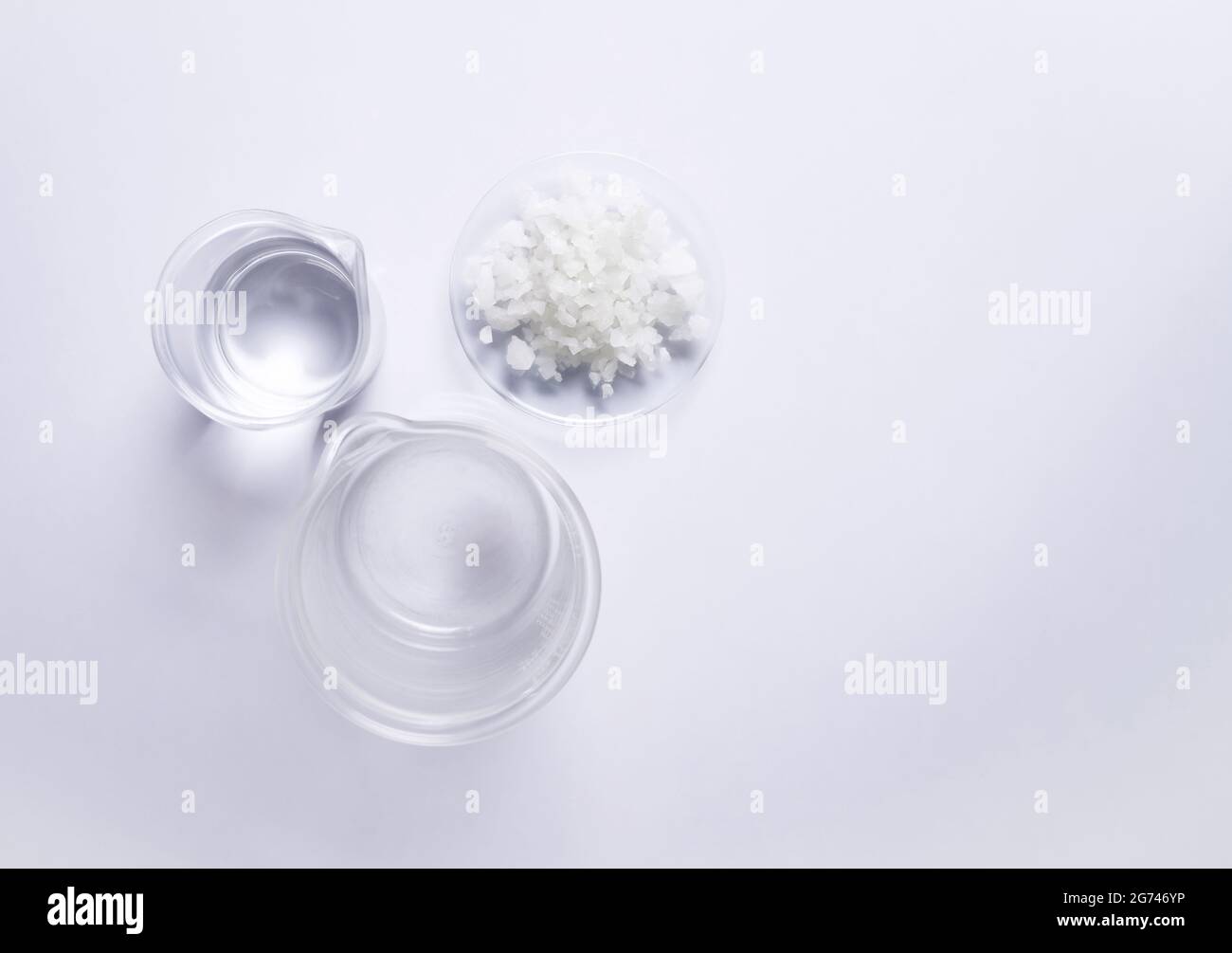 Crystal clear liquid in beaker, Flake salt in Chemical Watch Glass ...