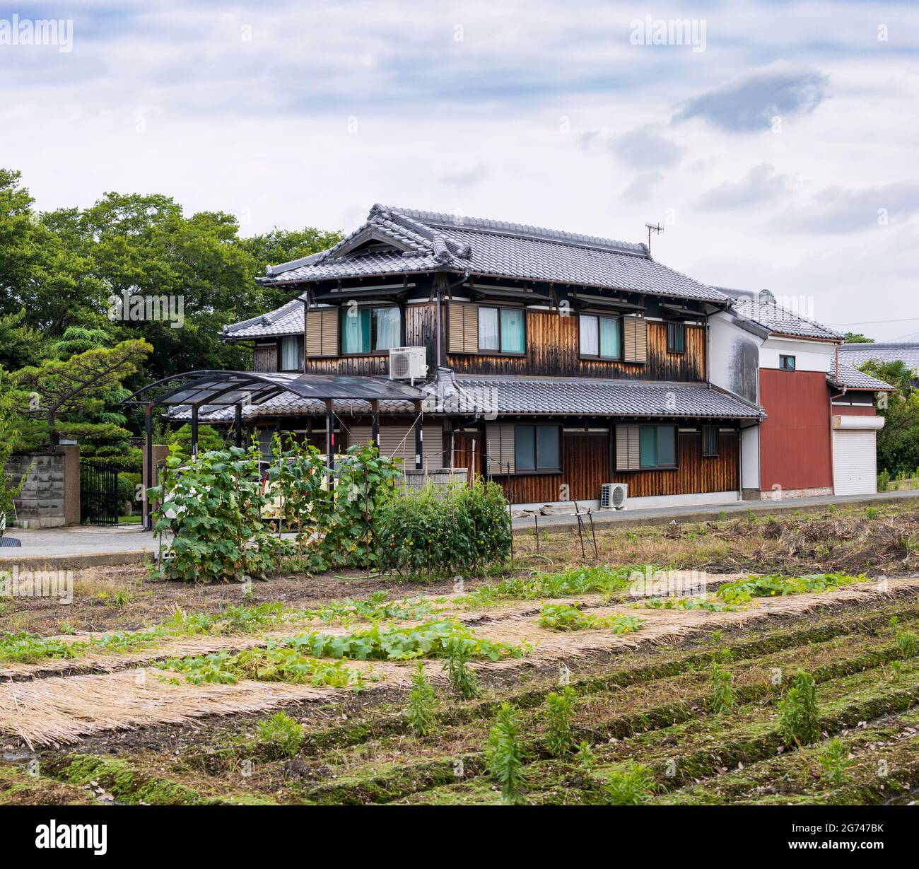 Old Japanese wooden house beside empty farmland and small garden Stock ...