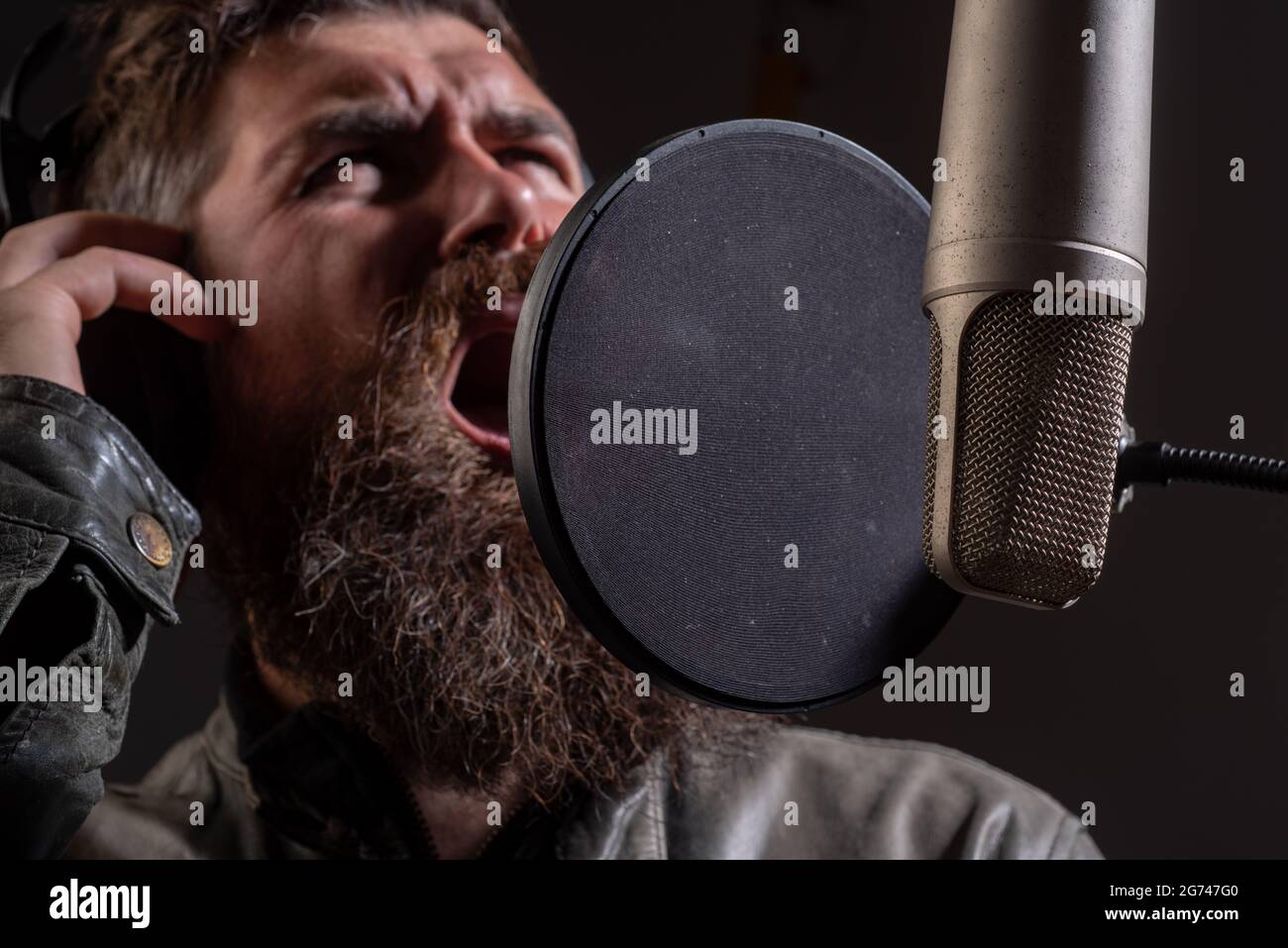 Karaoke singer. Expressive face closeup. Man singing with music ...