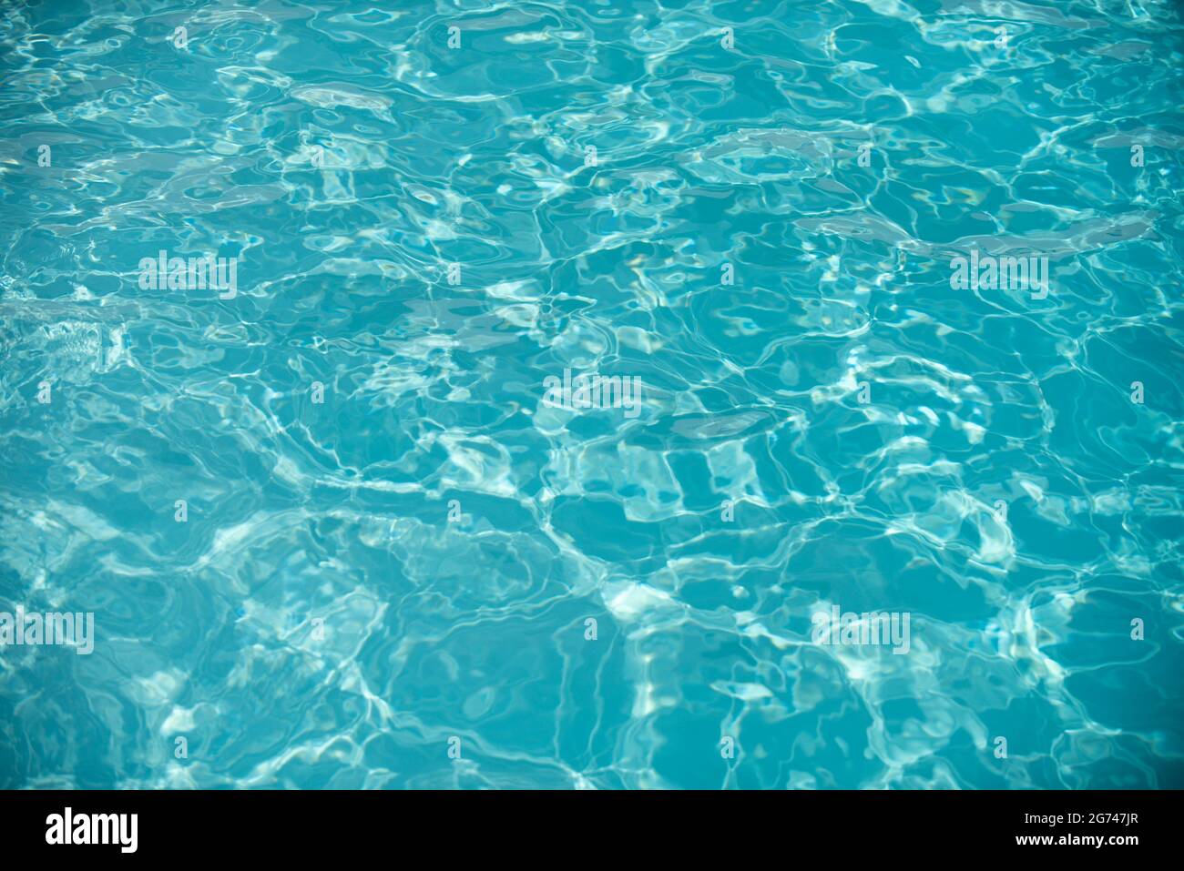Abstract ripple wave and clear turquoise water surface in swimming pool ...