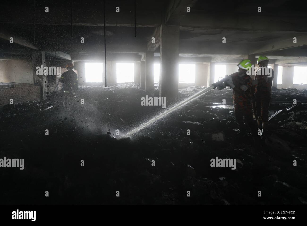 Firefighters work at the site of a fire that broke out on Thursday ...